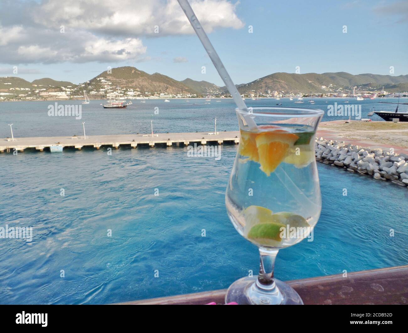 Glass of water with fresh lime and lemon slices sitting on a cruise ...