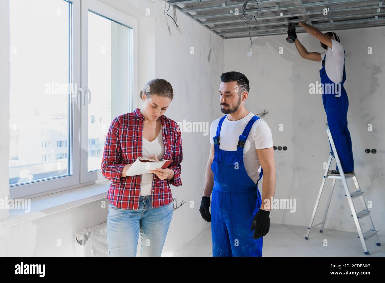 A female brigadier evaluates the work of a construction crew and talks ...