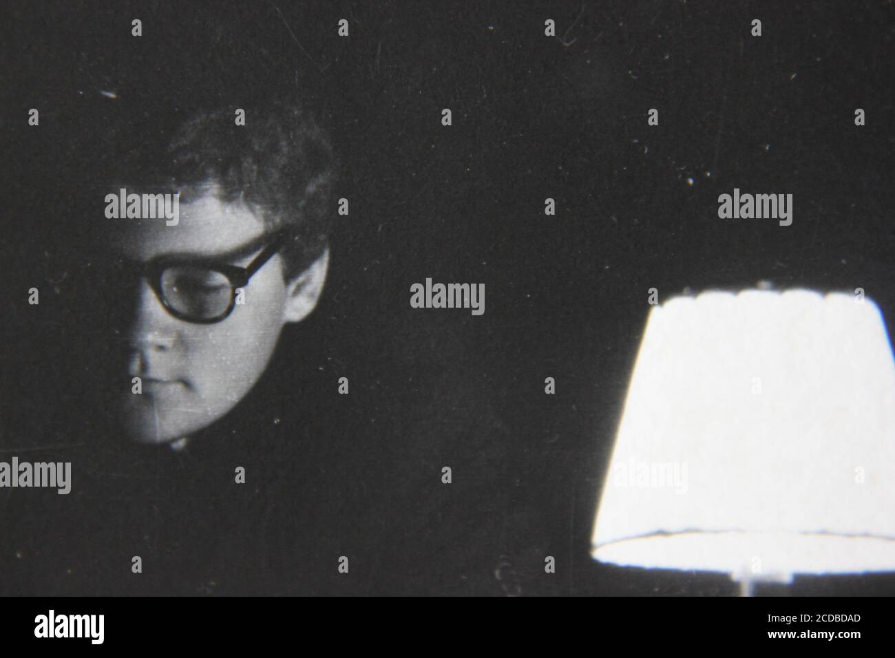 Fine 1970s vintage black and white photography of a studious young man working on his studies ...