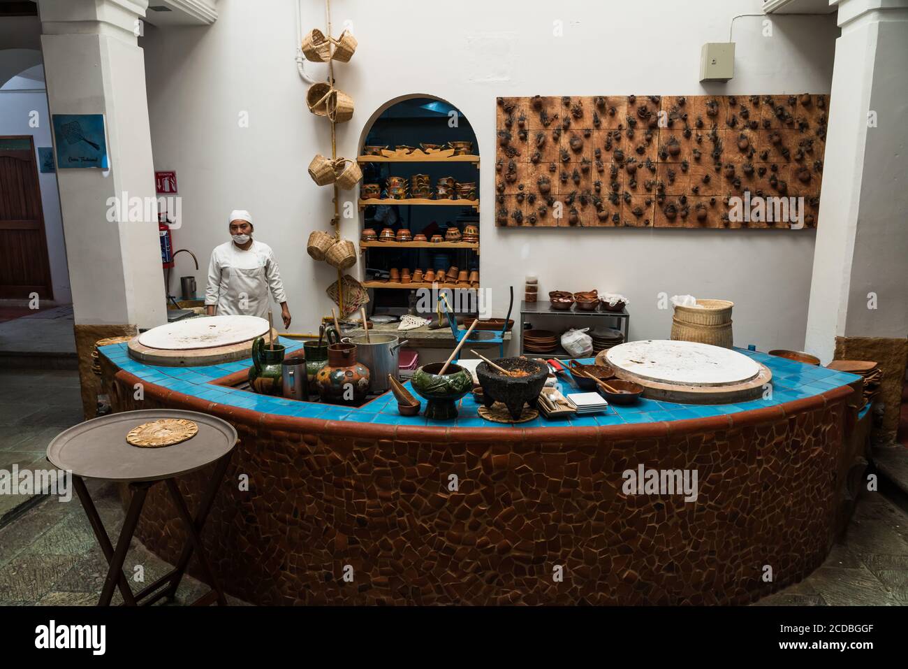 A traditional style kitchen in a restaurant with a comal (griddle) for ...