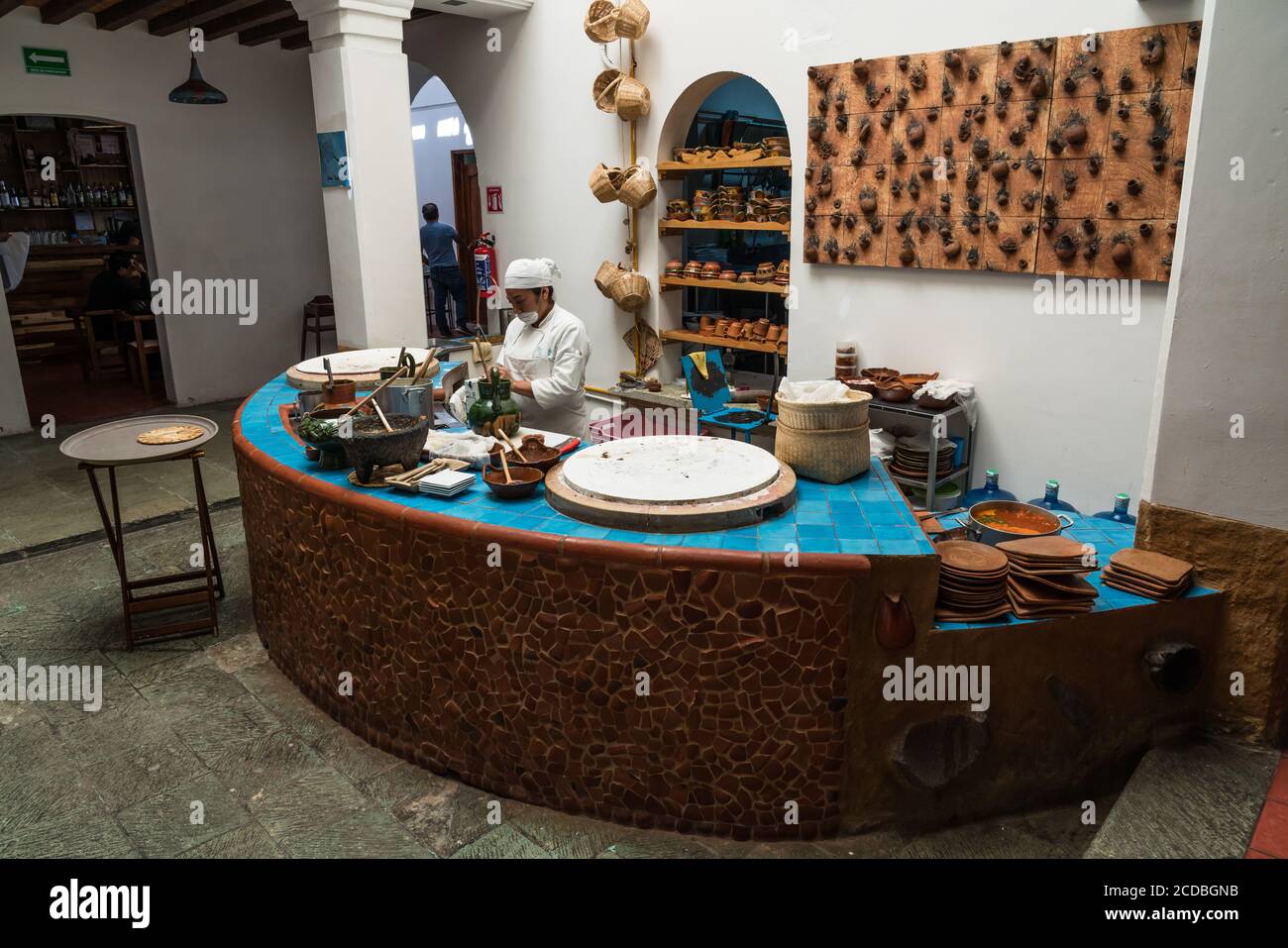 A traditional style kitchen in a restaurant with a comal (griddle) for ...
