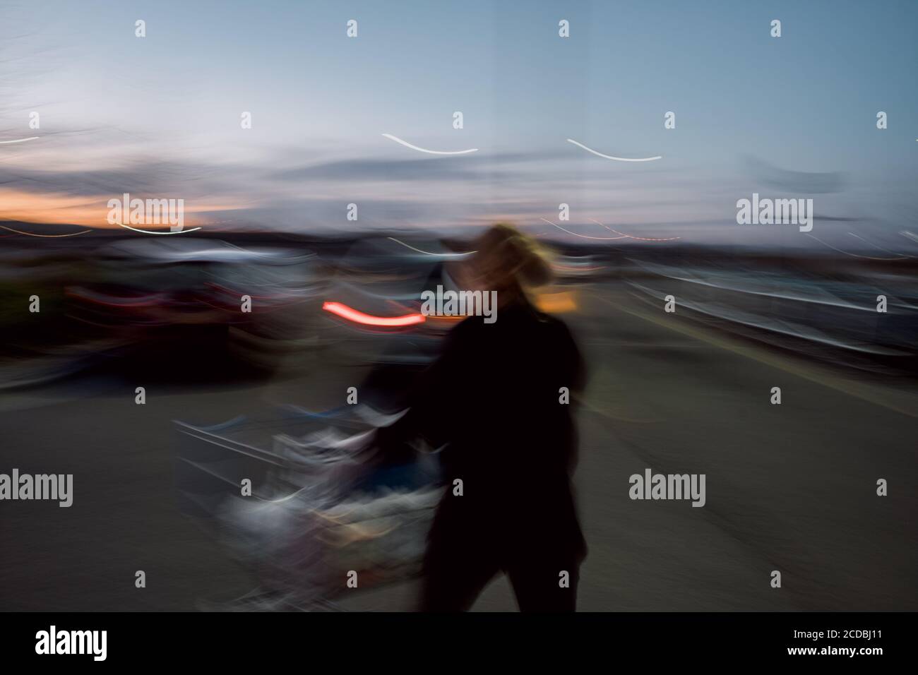 Frantic shopper pushing shopping cart outside store Stock Photo - Alamy