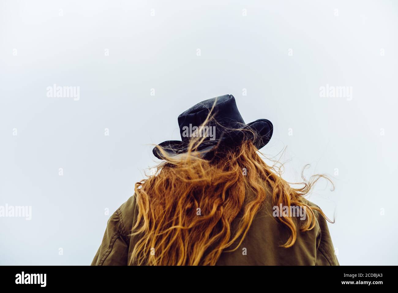 Confident western woman with cowboy hat walks around the snow with her ...