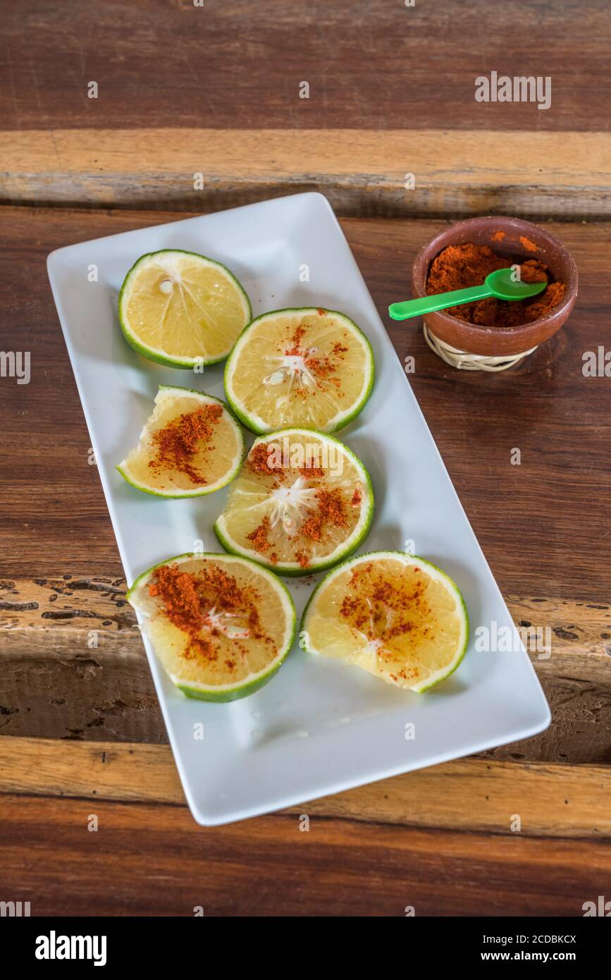Sal de gusano on lime slices at an artisanal mezcal distillery, a ...