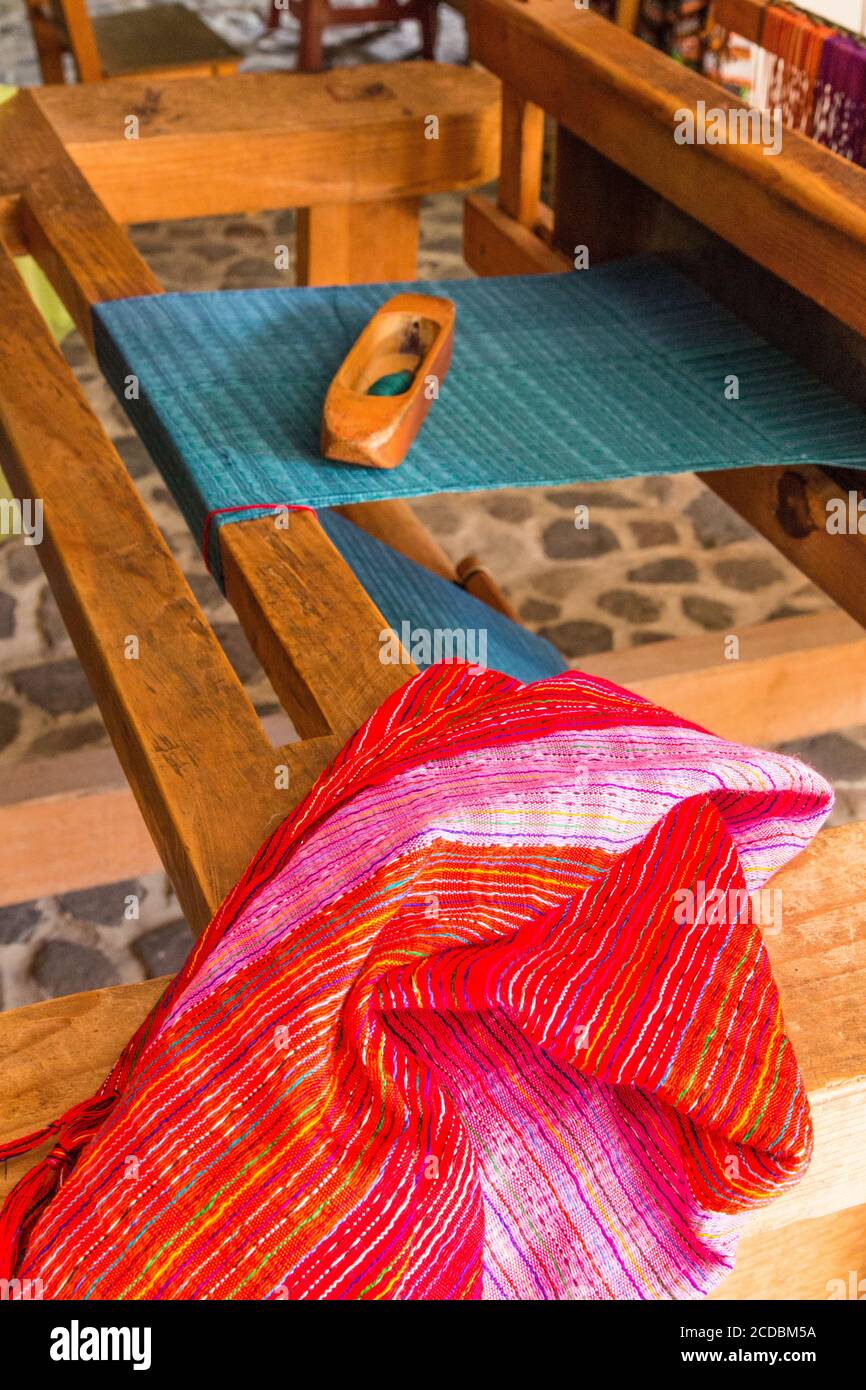 Finished fabric and a wooden weaving shuttle on the woven cloth on a ...