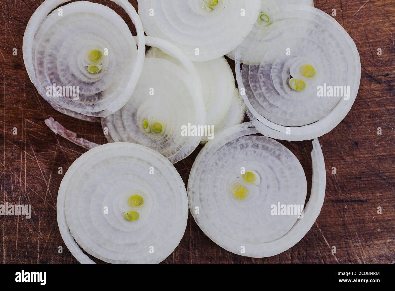 simple food ingredients concept, fresh onion cut into rings on cutting ...