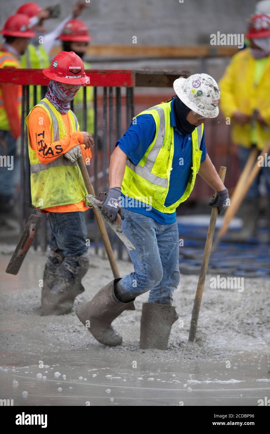 Crew construction workers pour concrete hi-res stock photography and ...