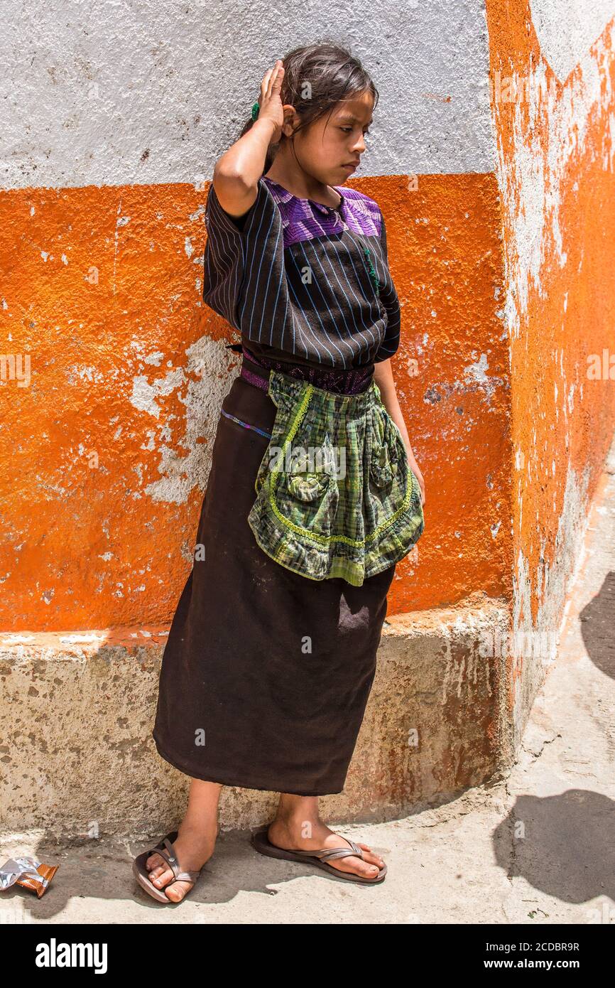 A teenaged Cakchiquel Mayan girl wearing traditional dress in the small ...