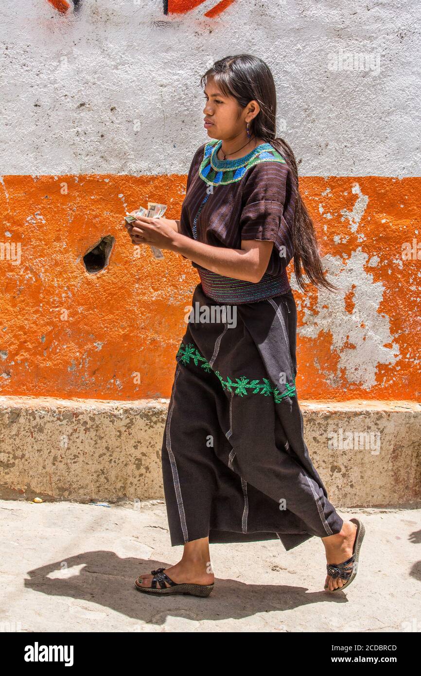 A young Cakchiquel Mayan woman wearing traditional dress in the small ...