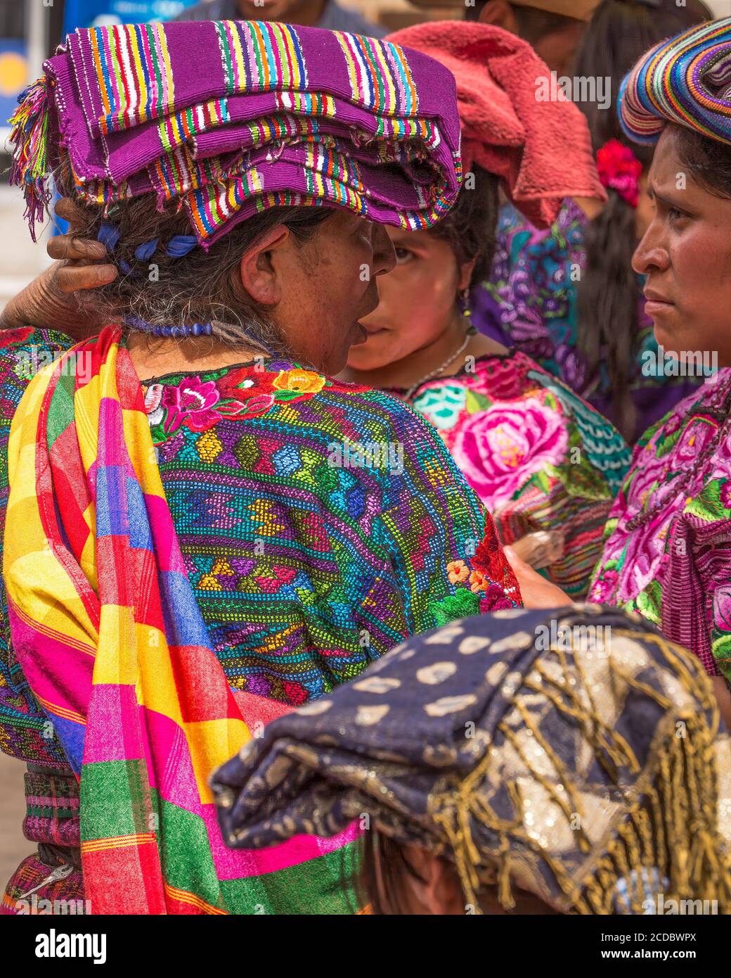 A Mayan woman in tradtional dress with her tzute utility cloth folded ...