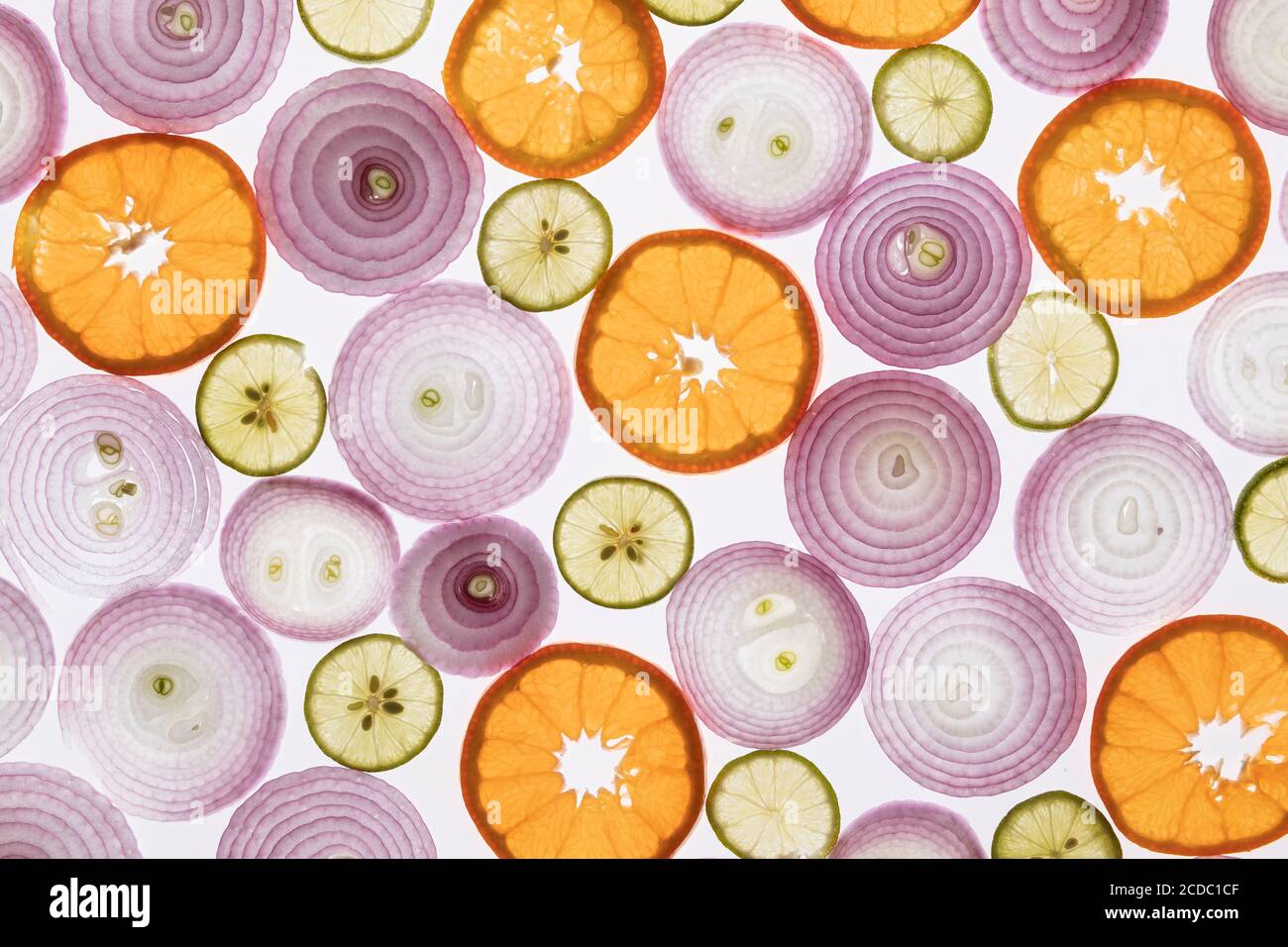 Onions, lemons and oranges background. Sliced onion, lemons and oranges ...
