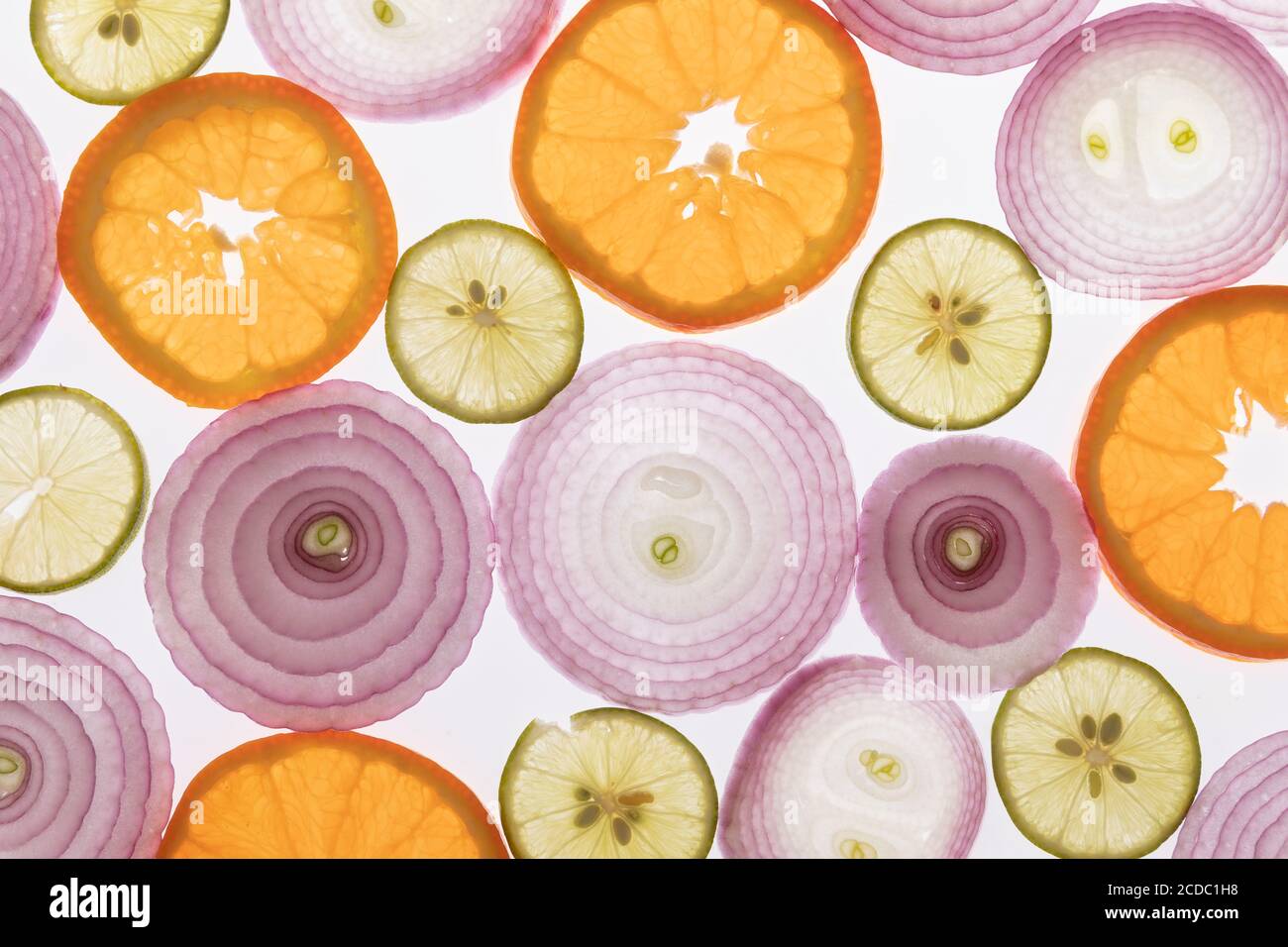 Onions, lemons and oranges background. Sliced onion, lemons and oranges ...