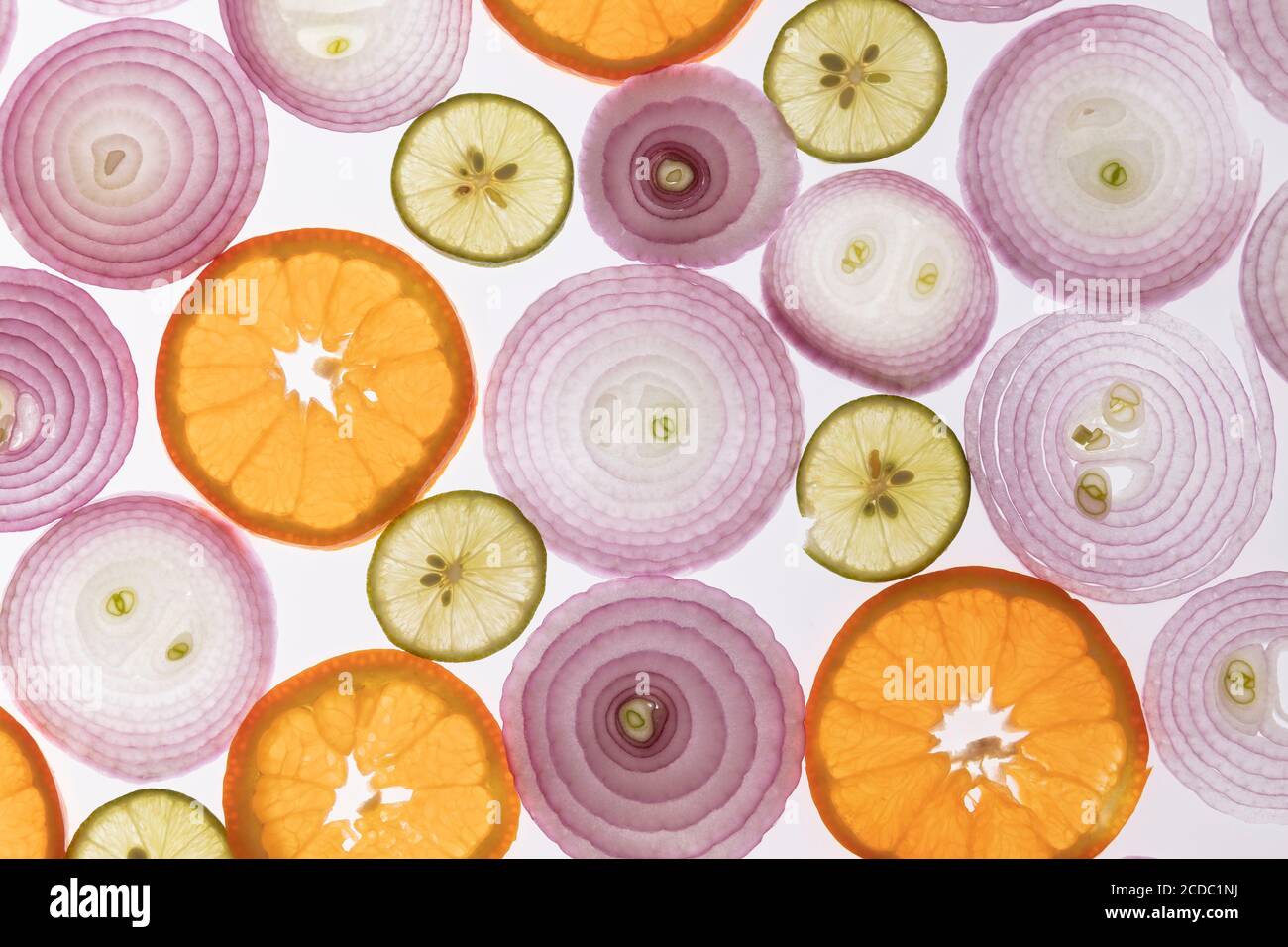 Onions, lemons and oranges background. Sliced onion, lemons and oranges ...
