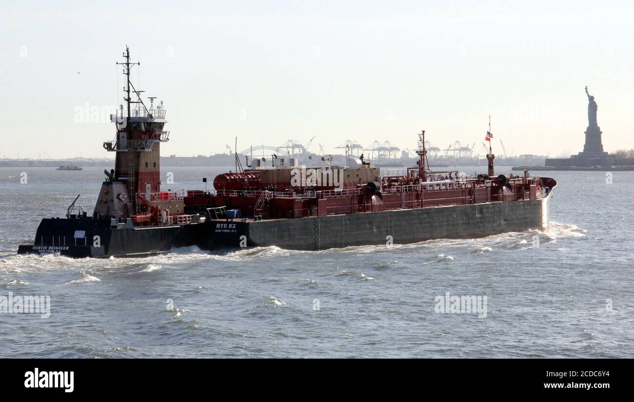 CURTIS REINAUER tugboat pushing a barge RTC 82 across New York Harbor ...