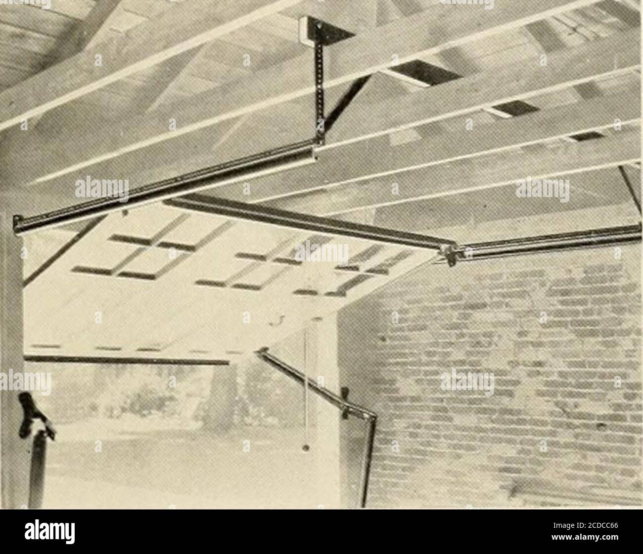 . "Over-the-top" door equipment for operating vertical doors overhead ...