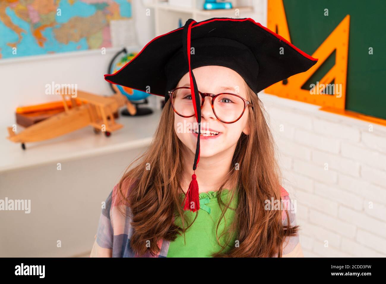 Funny little student girl in graduation cap. Child from elementary ...