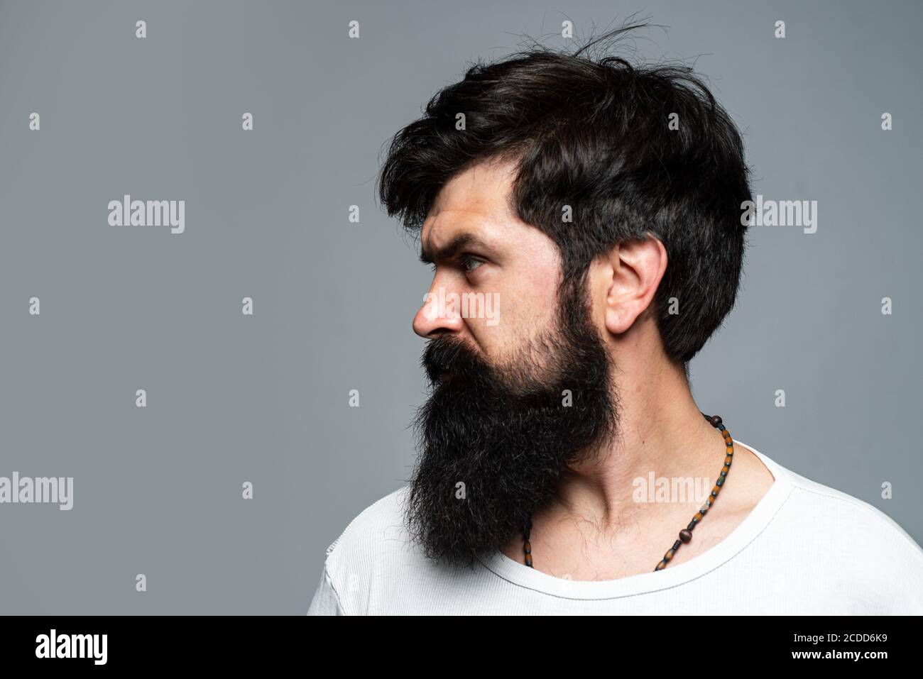 Half-turned side profile portrait of serious man has beard and mustache ...