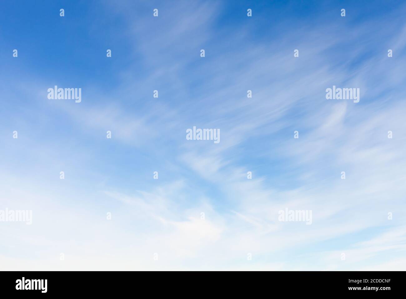 Blue sky with blurred windy clouds at daytime. Natural background photo ...