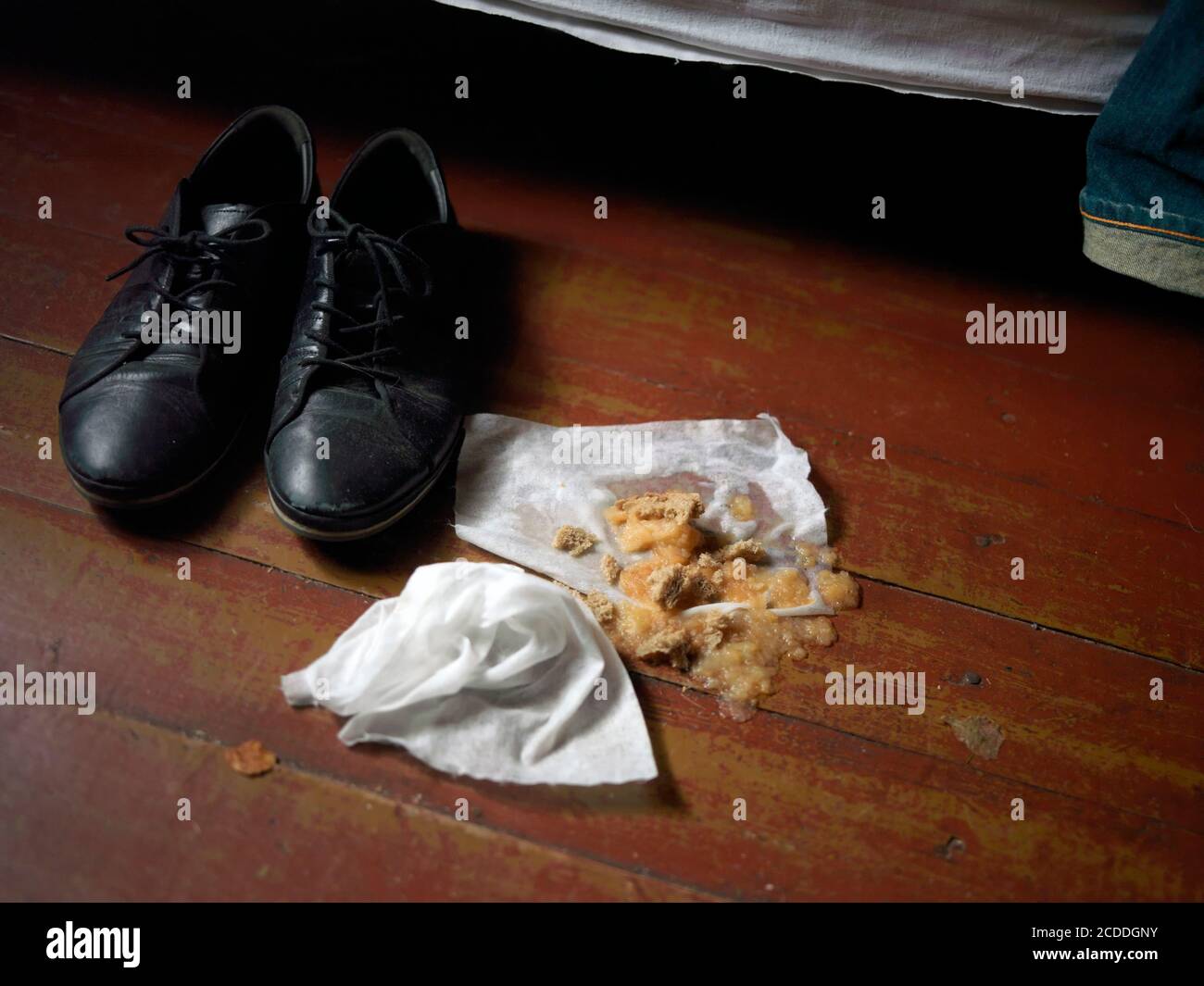 Messy floor with vomit next to a bed, indoor closeup Stock Photo - Alamy