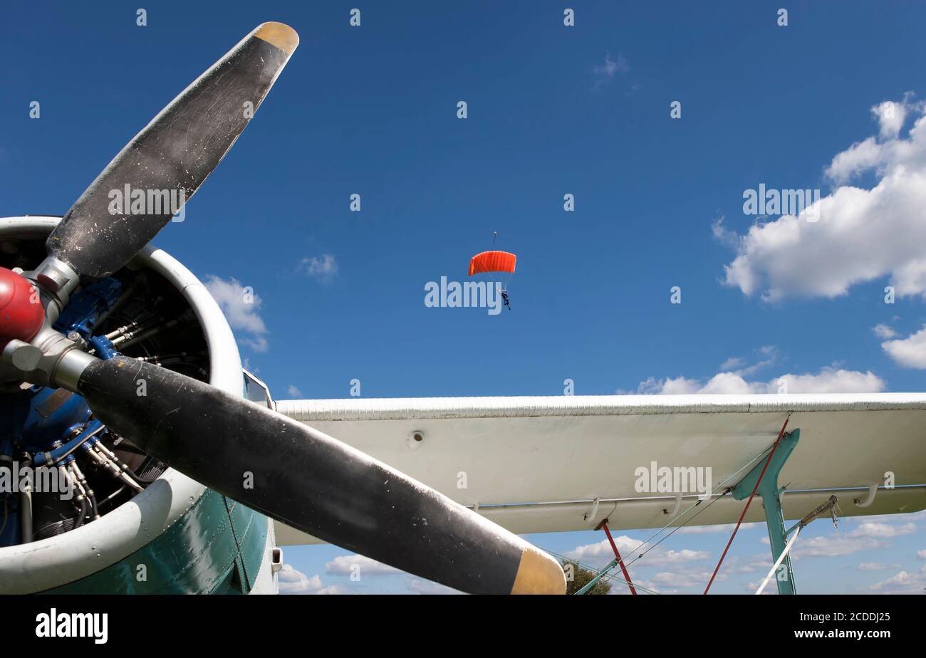 A front of a plane with propellers and landing parachutists Stock Photo ...