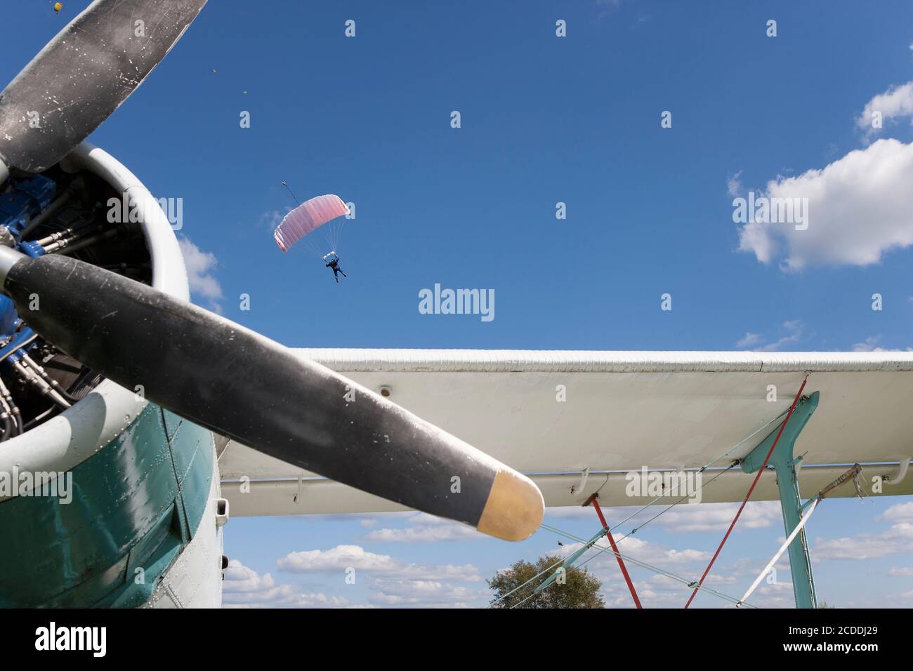 A front of a plane with propellers and landing parachutists Stock Photo ...