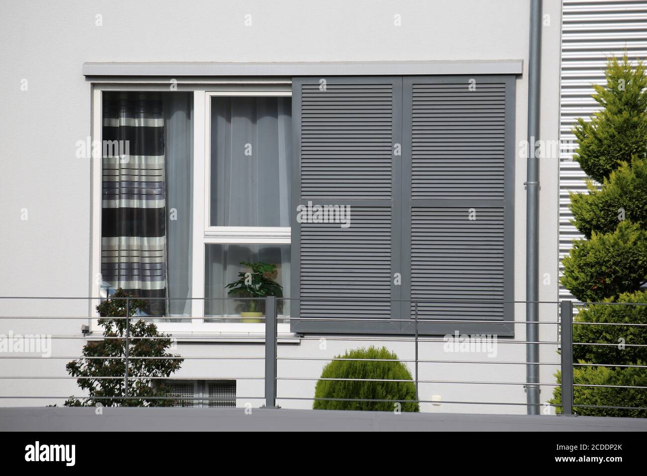 Windows with modern sliding shutters Stock Photo - Alamy