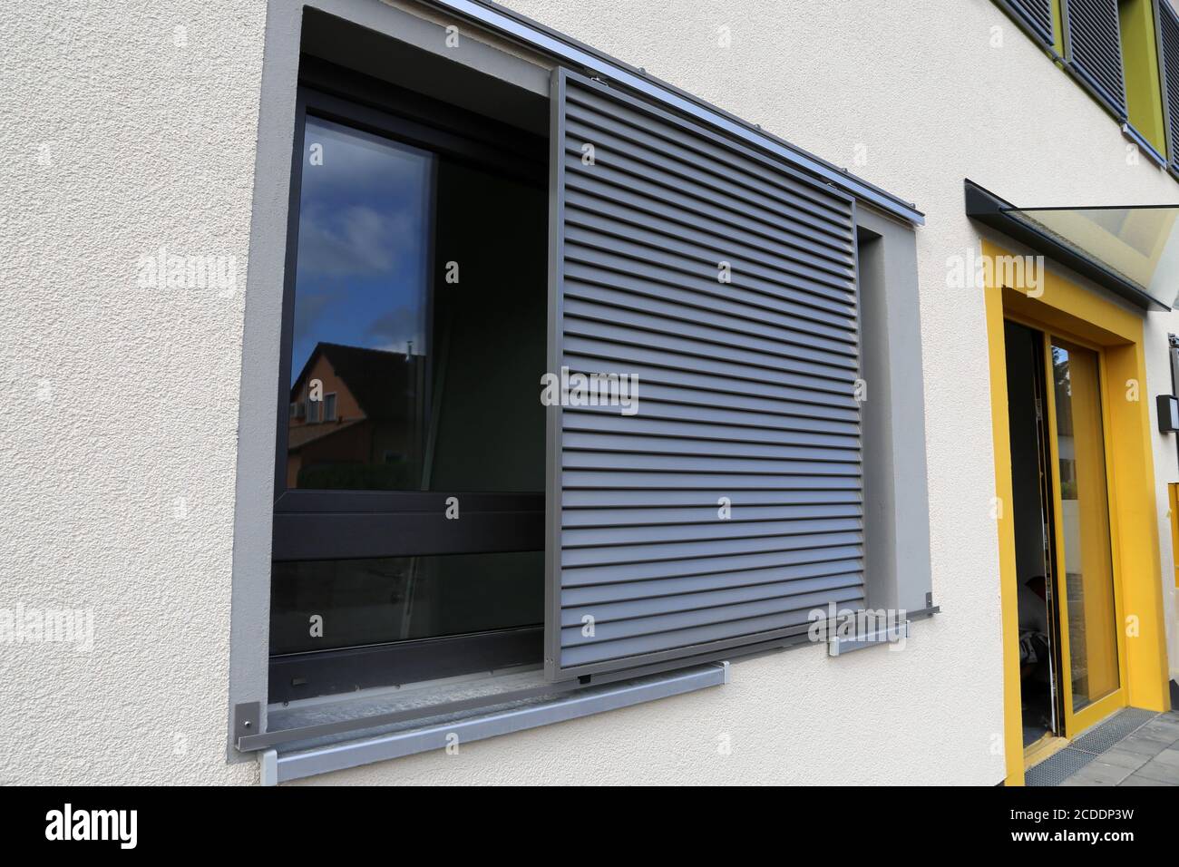 Windows with modern sliding shutters Stock Photo - Alamy