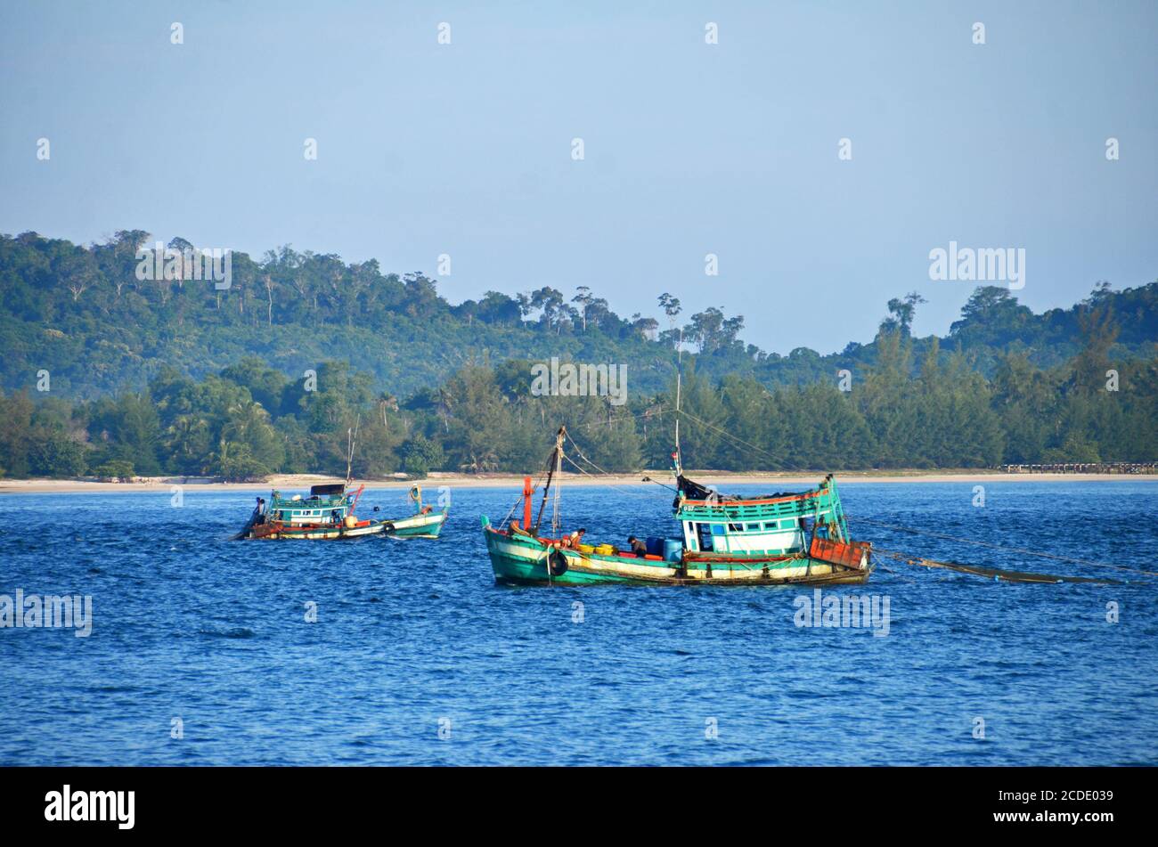 Fishing boats moored in the channel between the island of Koh Rong and ...