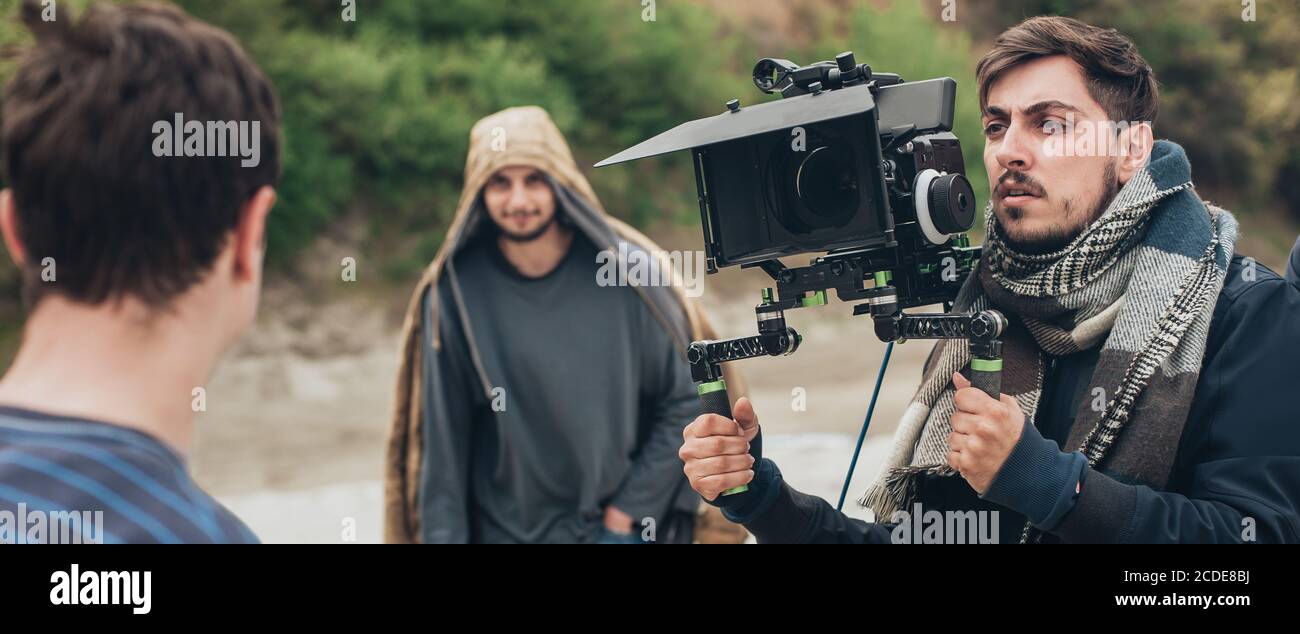 Behind the scene. Actor in front of the camera on the film set outdoor ...