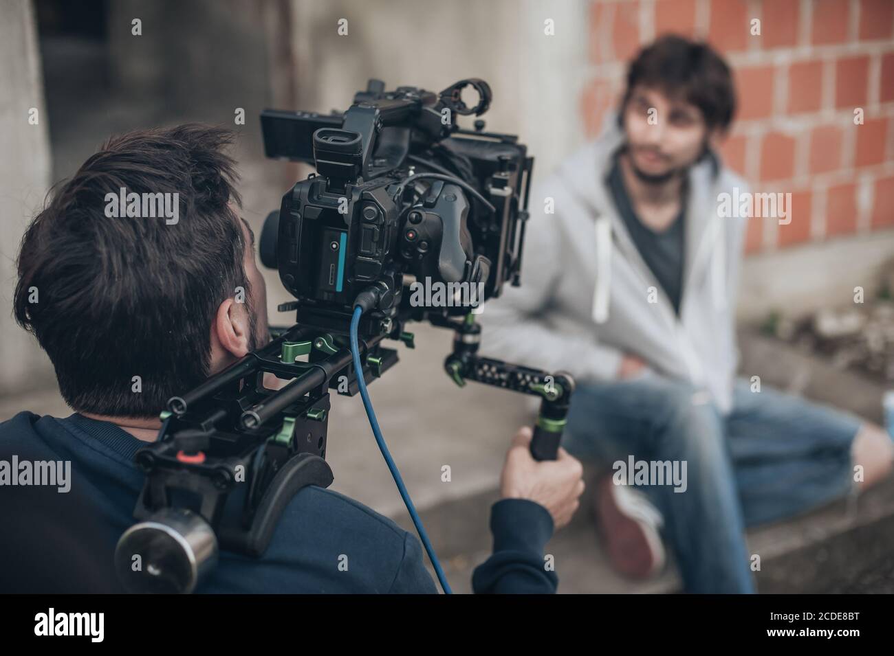 Behind the scene. Actor in front of the camera on the film set outdoor ...