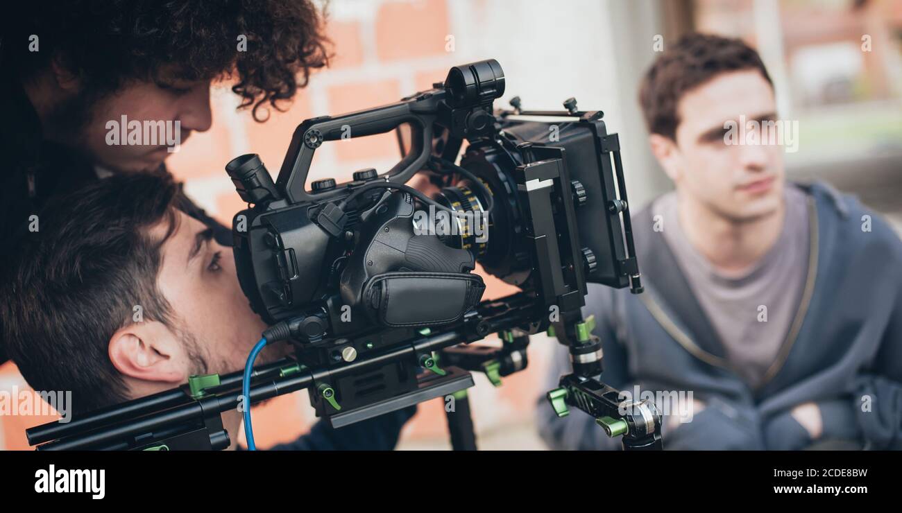 Behind the scene. Actor in front of the camera on the film set outdoor ...