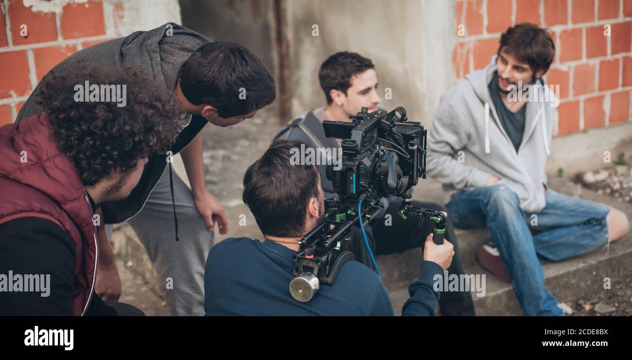 Behind the scene. Actor in front of the camera on the film set outdoor ...