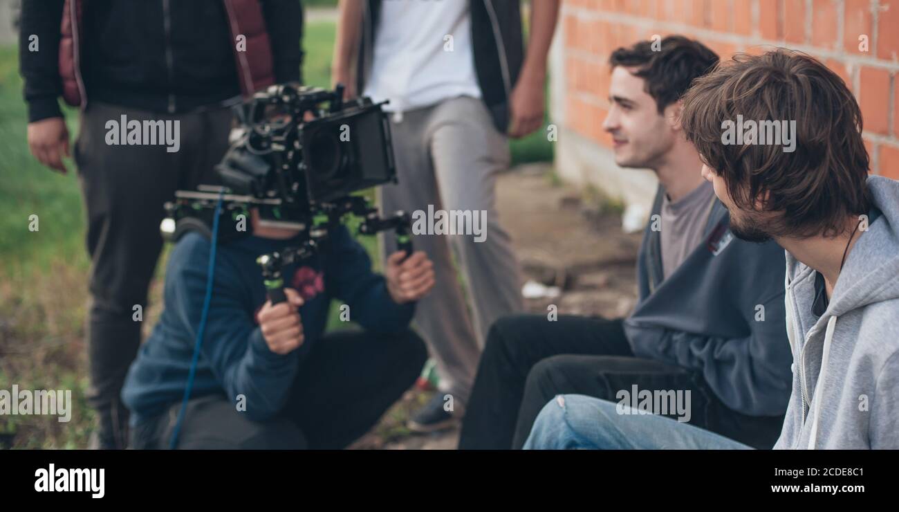 Behind the scene. Actor in front of the camera on the film set outdoor ...