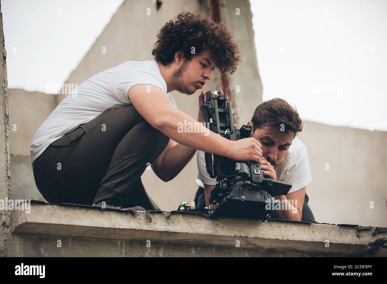Behind the scene. Cameraman and assistant shooting the film scene with ...