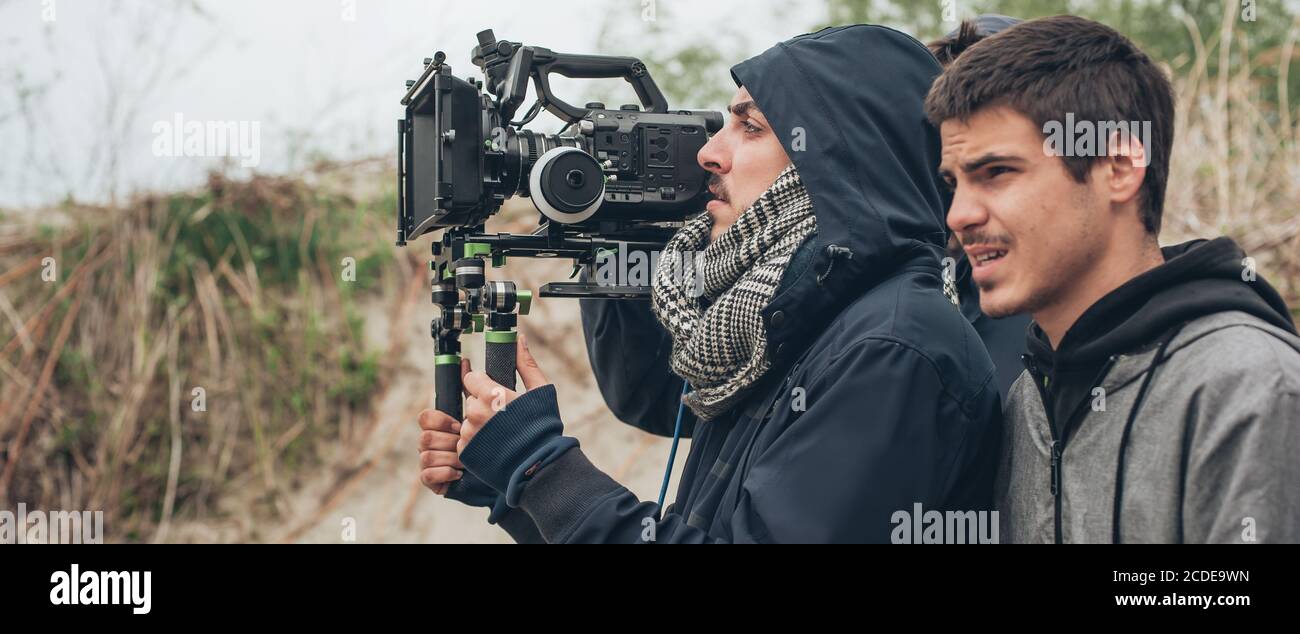 Behind the scene. Cameraman and film director shooting film scene on ...