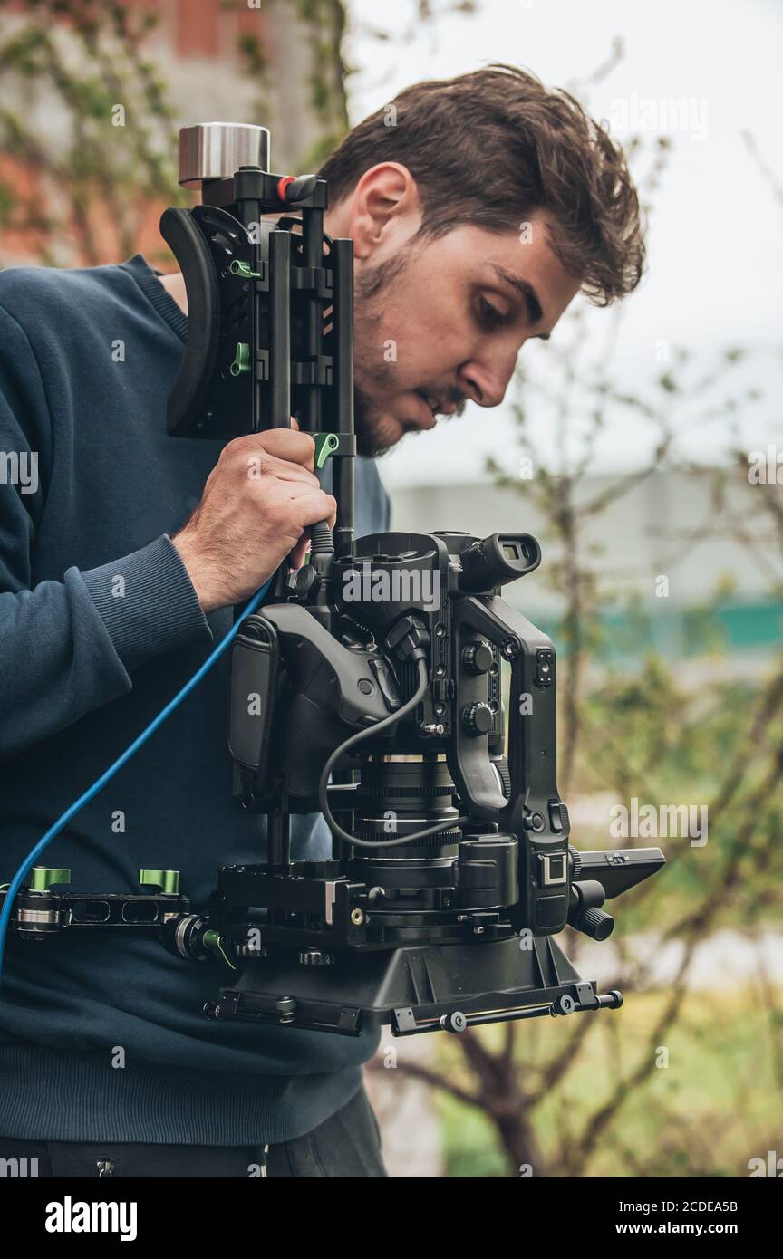 Behind the scene. Cameraman shooting the film scene with his camera on ...