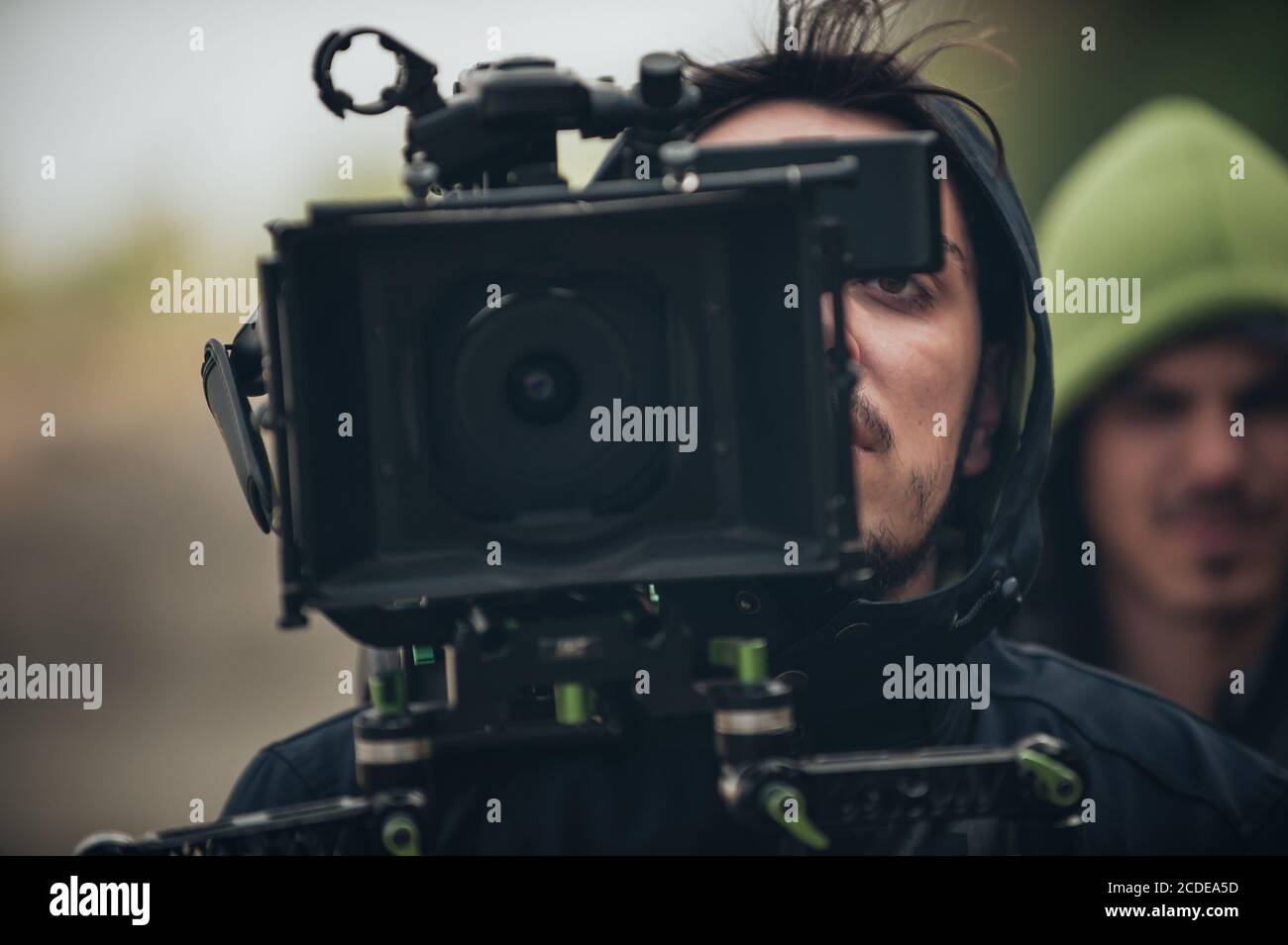 Behind the scene. Cameraman shooting the film scene with his camera on ...