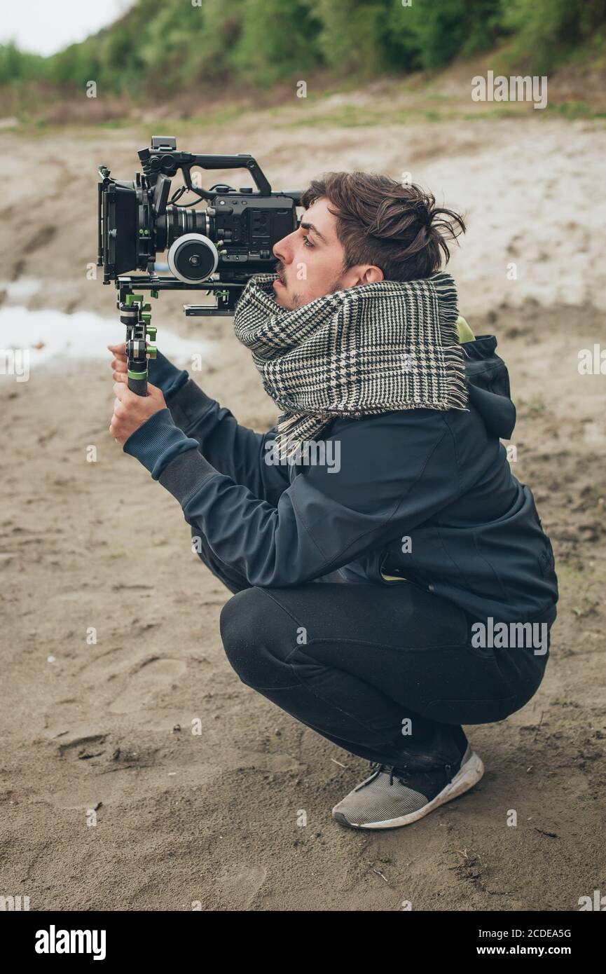 Behind the scene. Cameraman shooting the film scene with his camera on ...