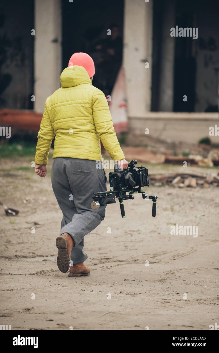 Behind the scene. Cameraman with his camera on outdoor location Stock ...