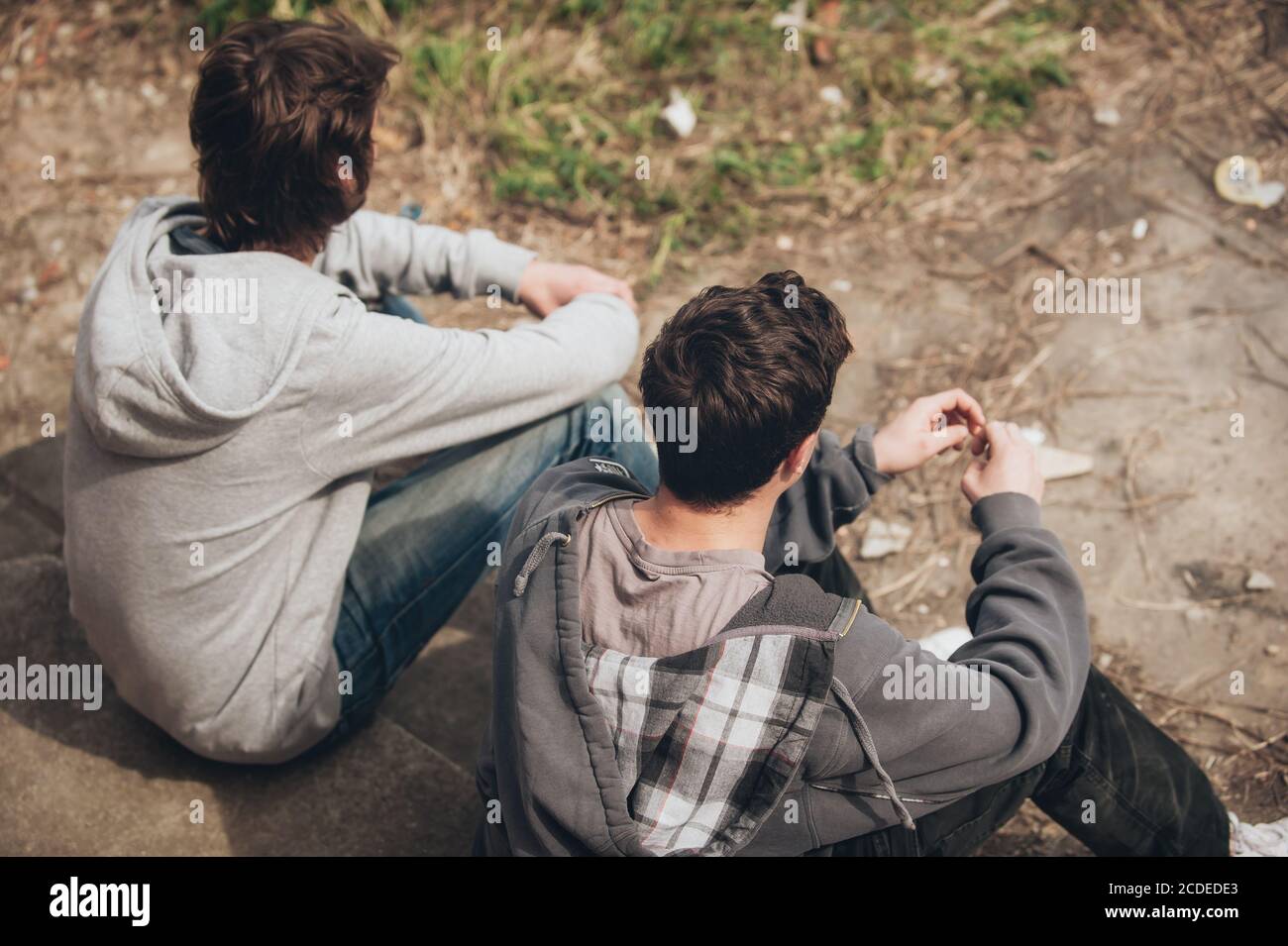 Two depressed and sad young buddies friends thinking together about ...