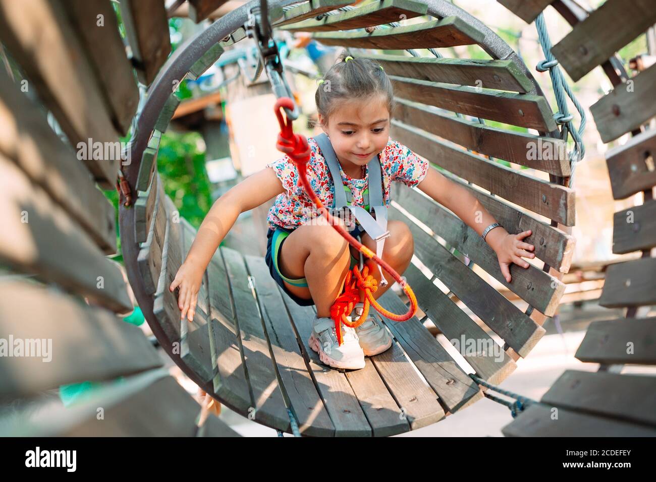 Rope Park. The kid passes the obstacle in the rope Park Stock Photo - Alamy
