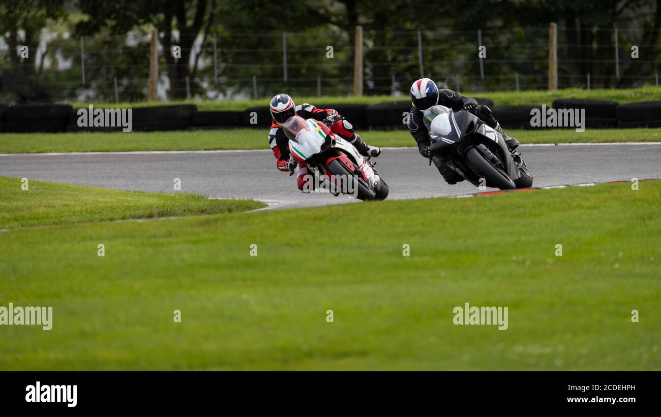 A shot of several racing bikes cornering as they circuit a track Stock ...