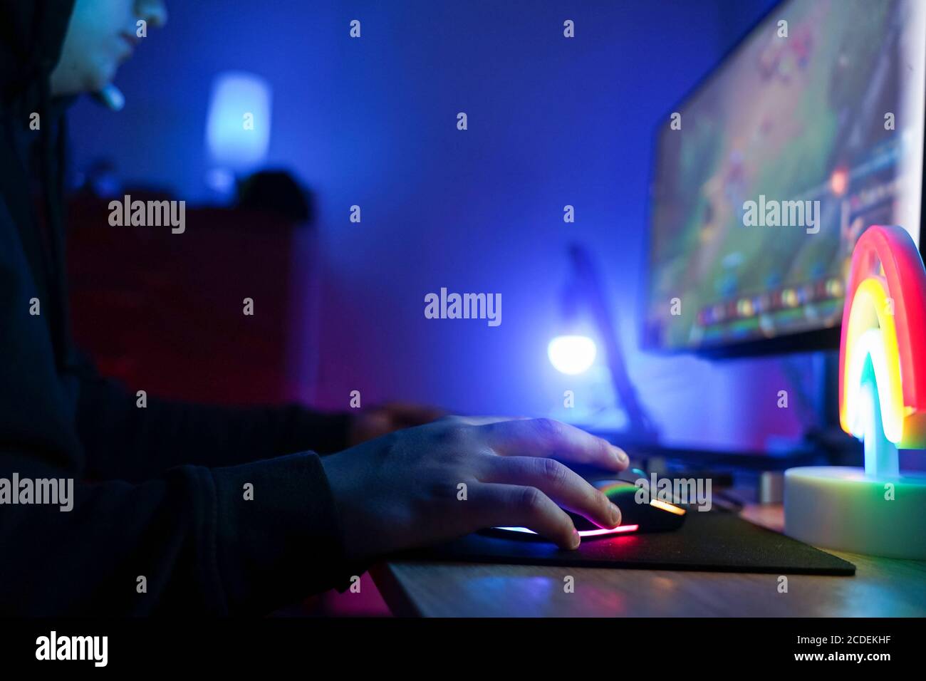 Young gamer playing video game wearing gaming mouse. Gamer concentrated ...