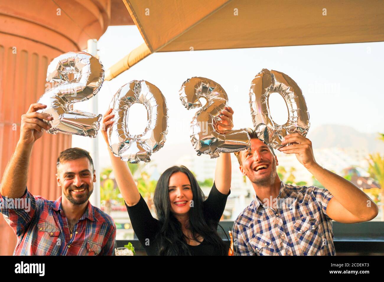 Group of younger people friends with different ages celebrate together ...