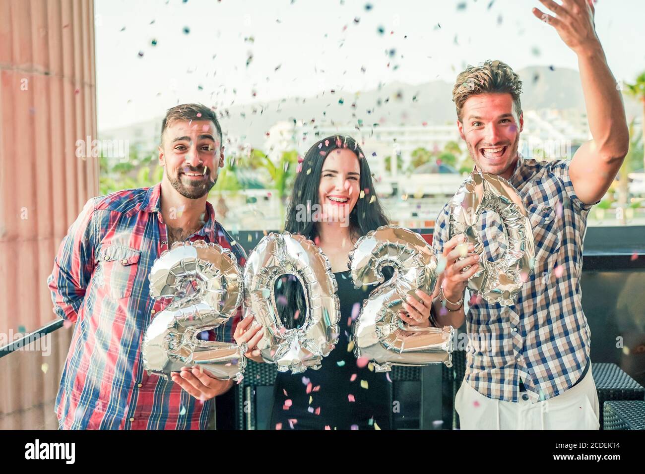 Group of younger people friends with different ages celebrate together ...