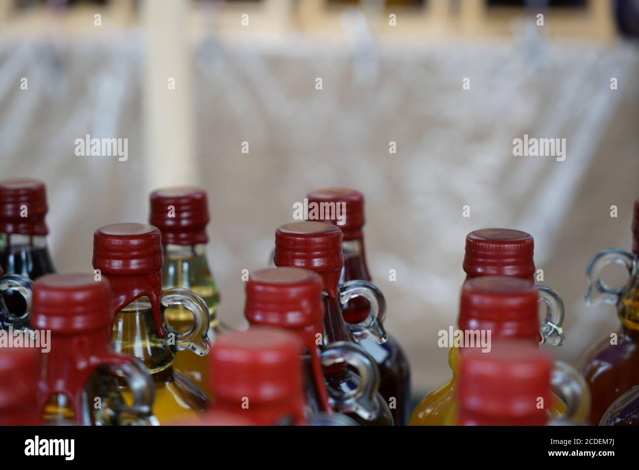 Cooking oil in the glass bottles with red lids Stock Photo - Alamy