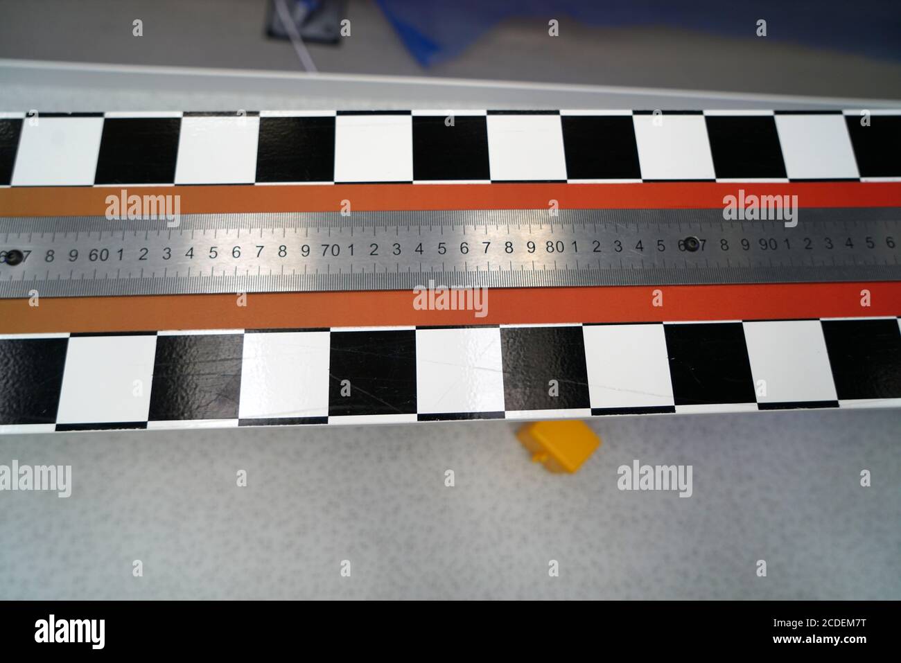 Long steel ruler attached to a surface Stock Photo - Alamy