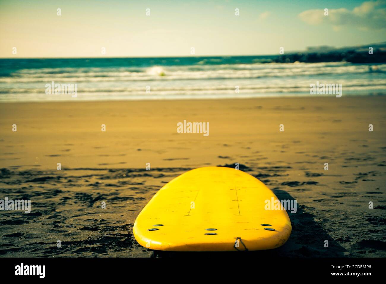 yellow surf boards in a stack by ocean. Surf board on sandy beach. Soft ...