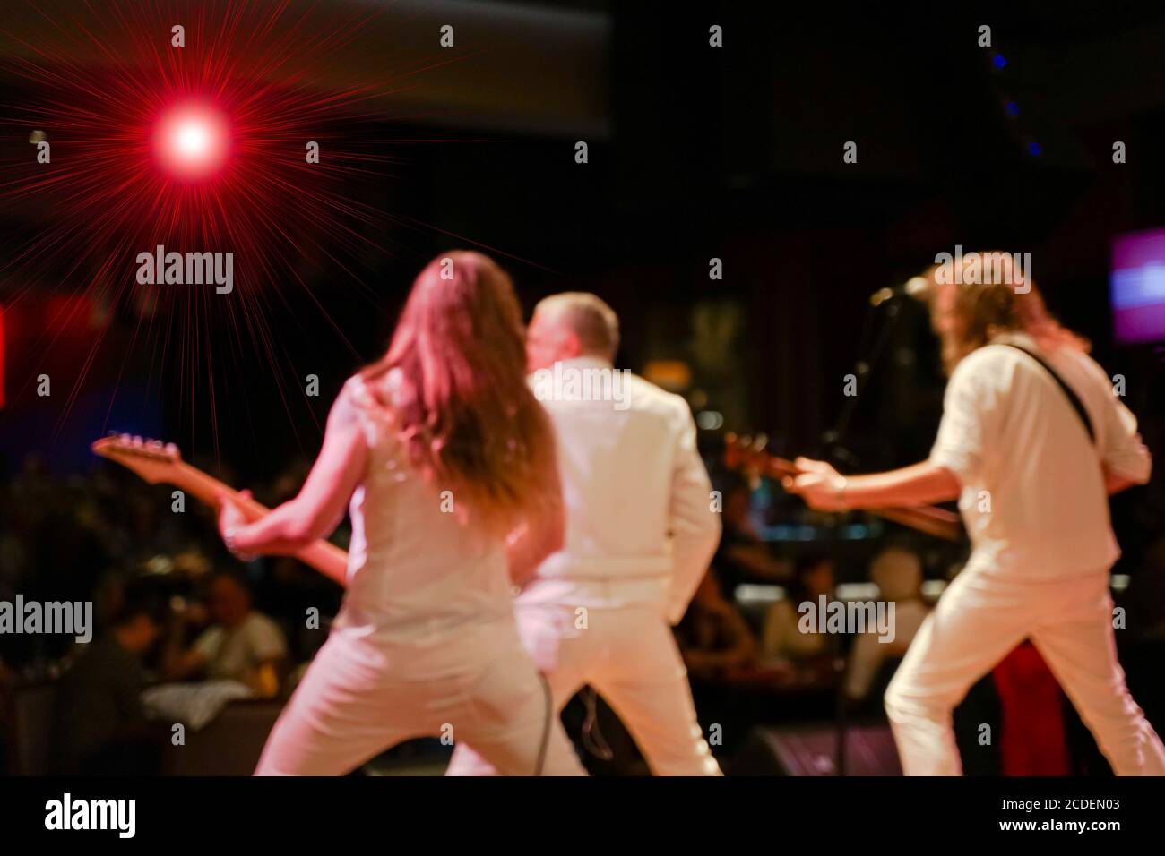 Band performs on stage, rock music concert. Warning - authentic ...