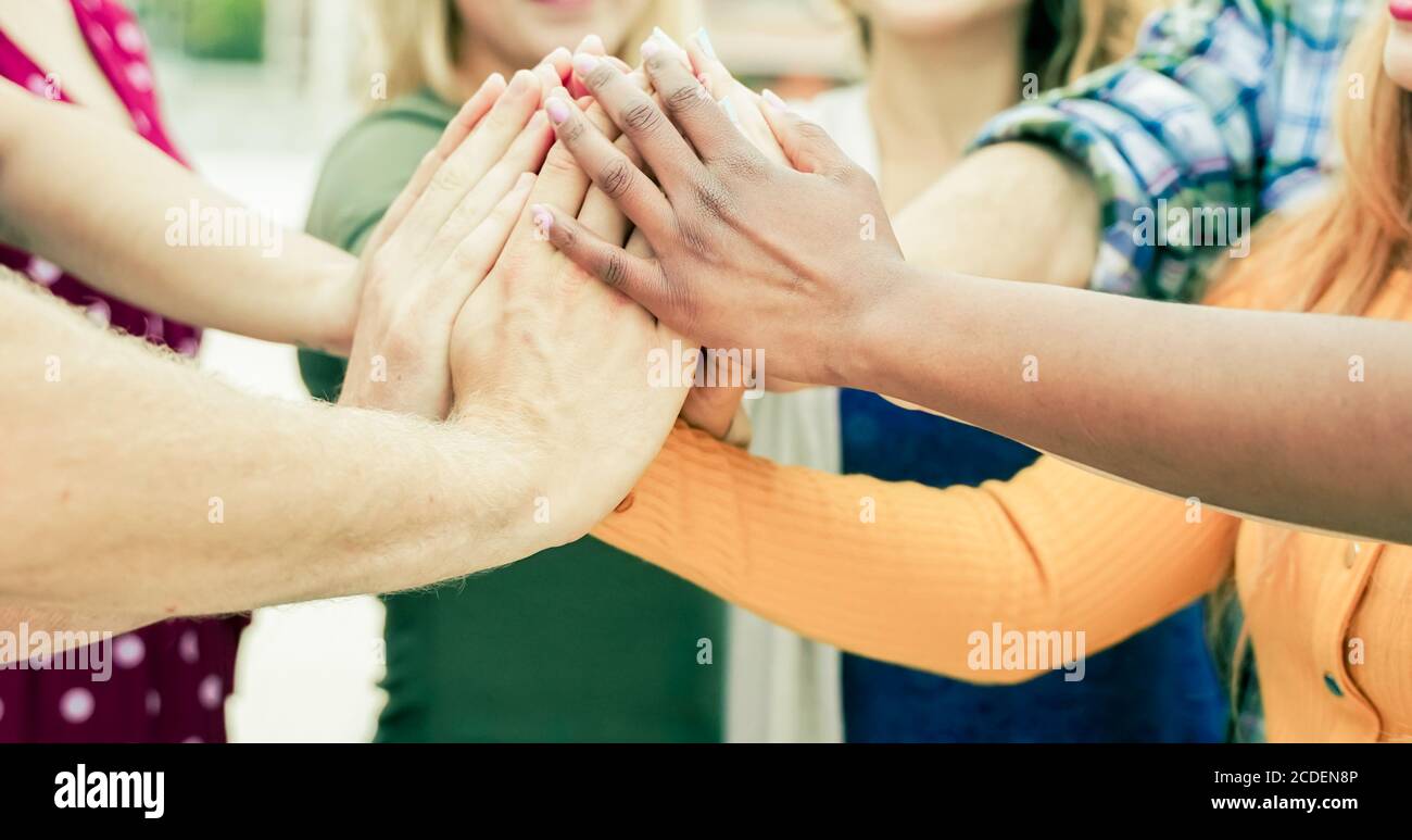 Young people putting their hands together. Friends with stack of hands ...